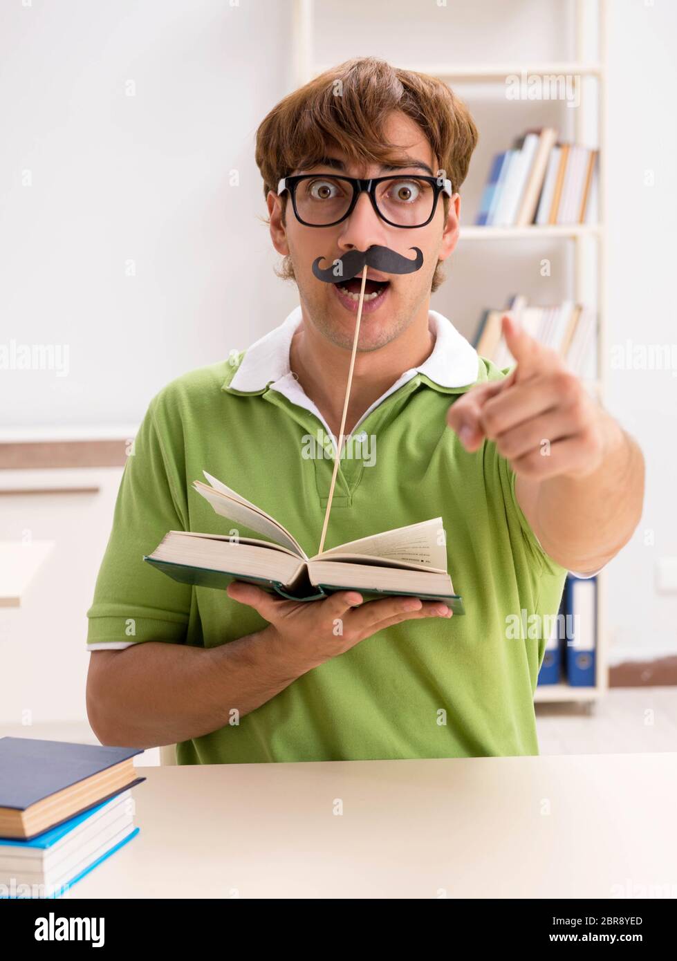 The student with fake moustache reading book Stock Photo - Alamy