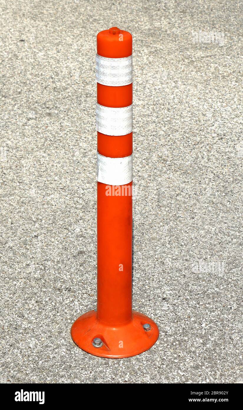 Orange parking pole outside on street asphalt Stock Photo - Alamy