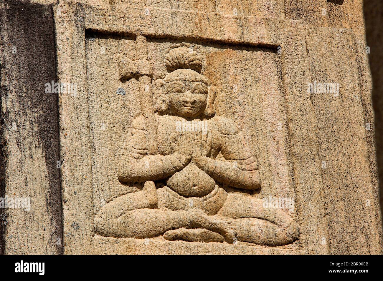 Bas relief sculpture of man with folded hands and legs at Rayara Gopura ...