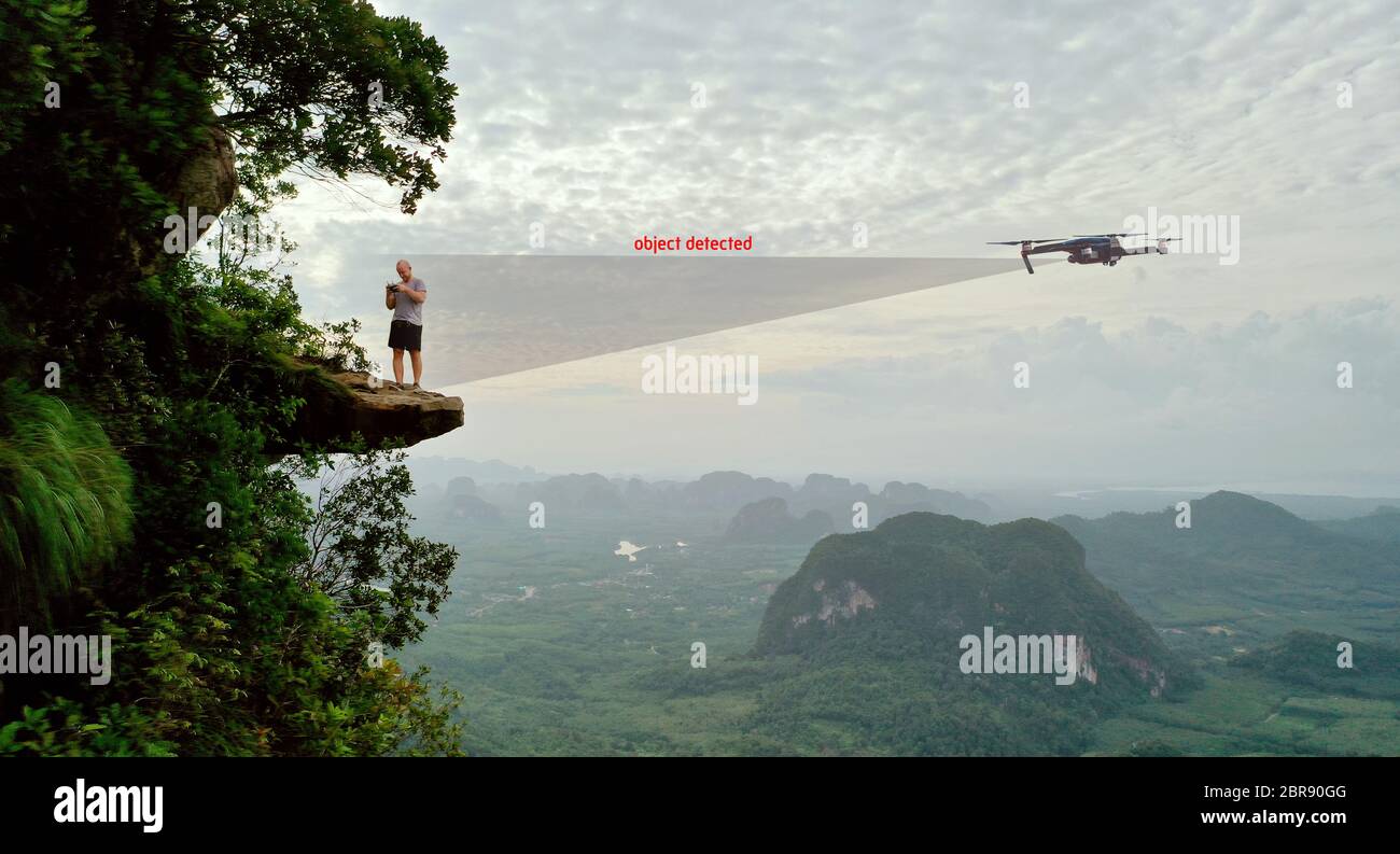 Aerial view of man drone operator on the edge of the rock over ...