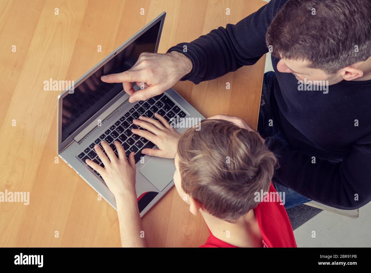father and son using computer togetherat home Stock Photo - Alamy