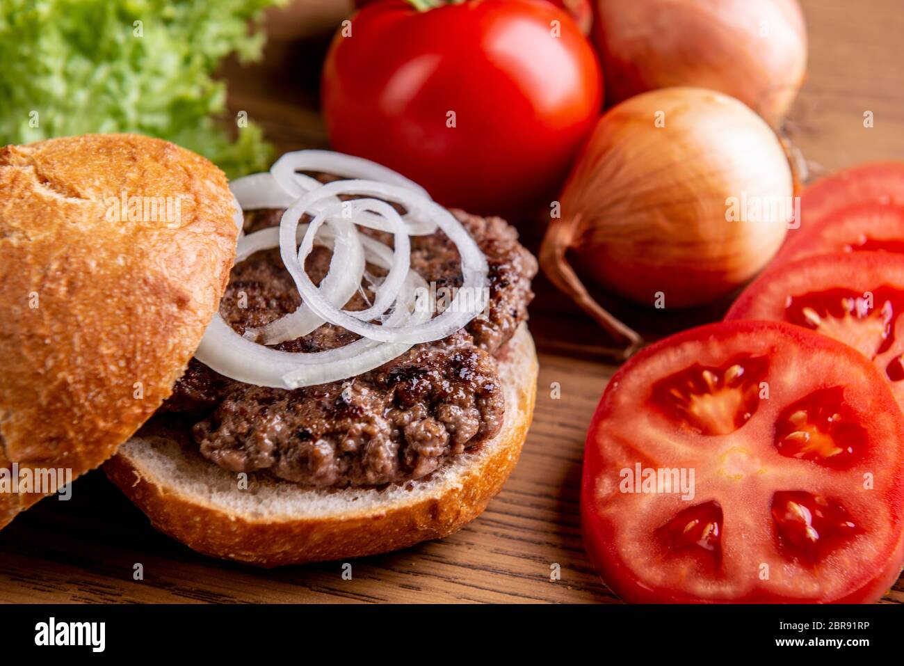 home made hamburger with meat, salad, onion, tomato Stock Photo - Alamy