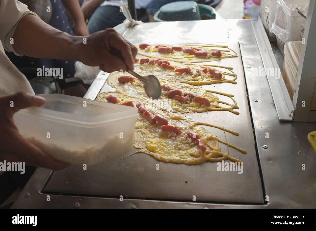 The man cooking Soft Waffle , Roll pancake stuffed with pork with ...