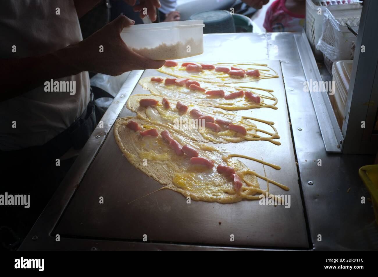 The man cooking Soft Waffle , Roll pancake stuffed with pork with ...