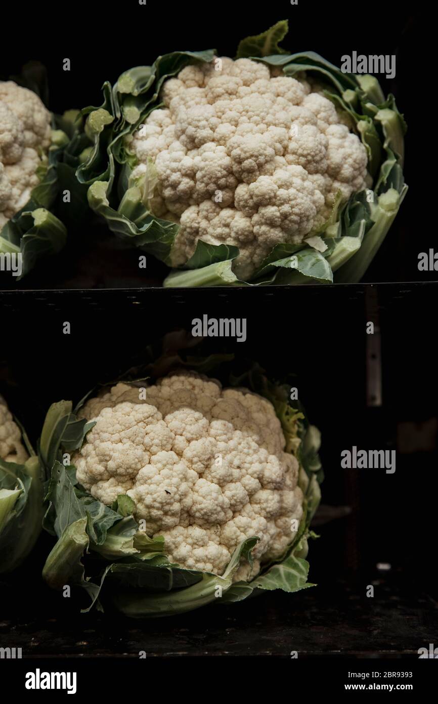 A close-up shot of an abundance of fresh cauliflower on display at a ...