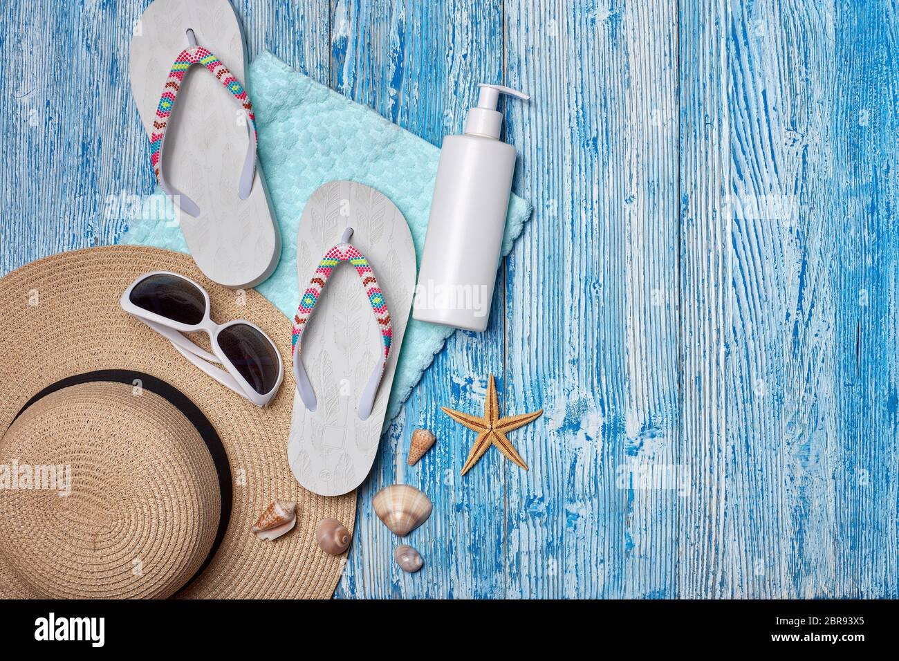 Beach accessories: white female flip flops, straw hat, sunglasses ...