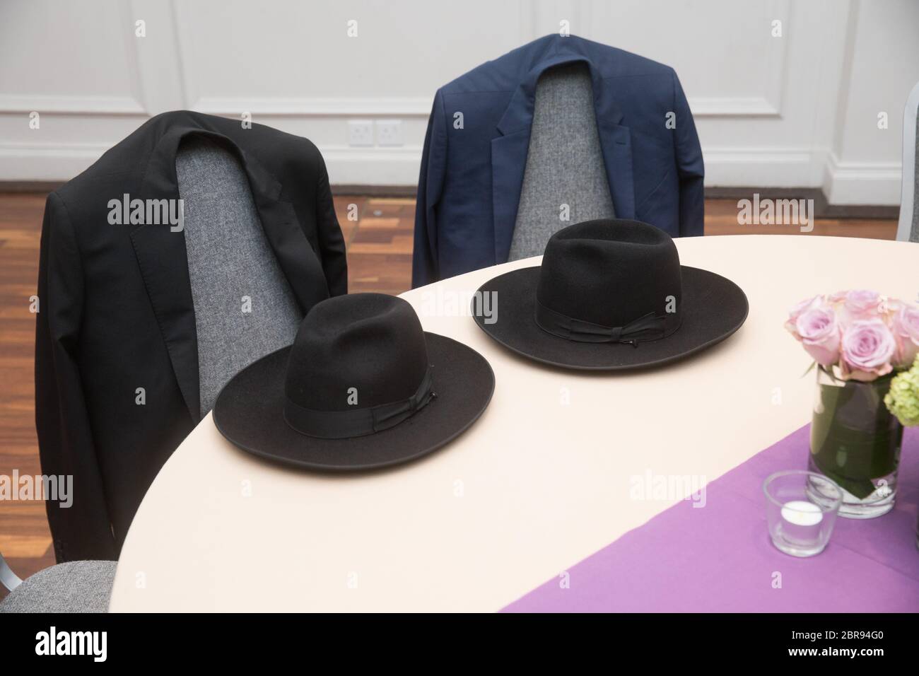 rabbi hats and jacket on table at a barmitzvah party celebration Stock ...