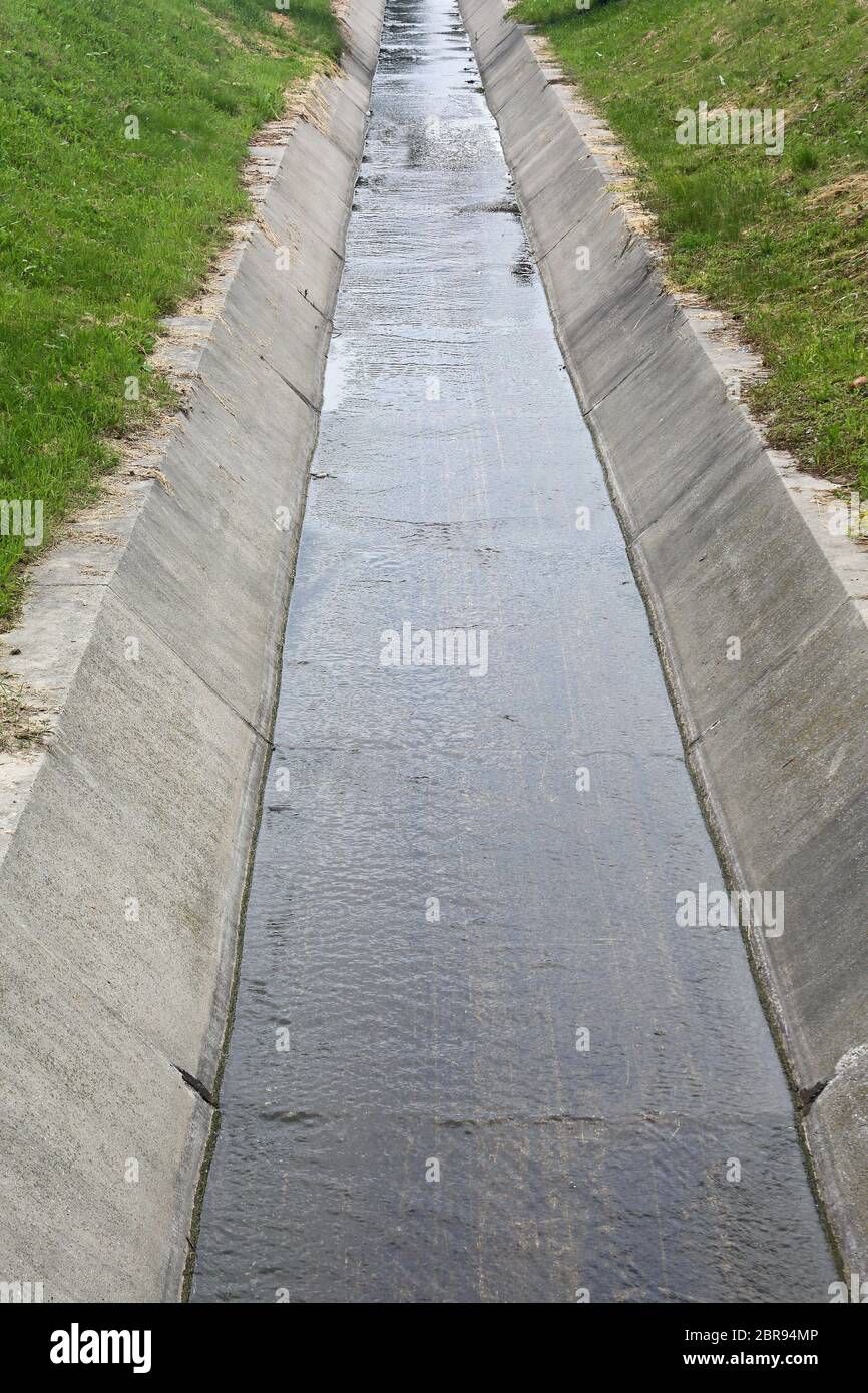 Straight concrete canal for water irrigation hi-res stock photography ...