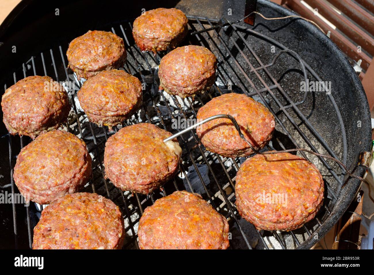 Big beef hamburger baking inside the barbecue Stock Photo - Alamy