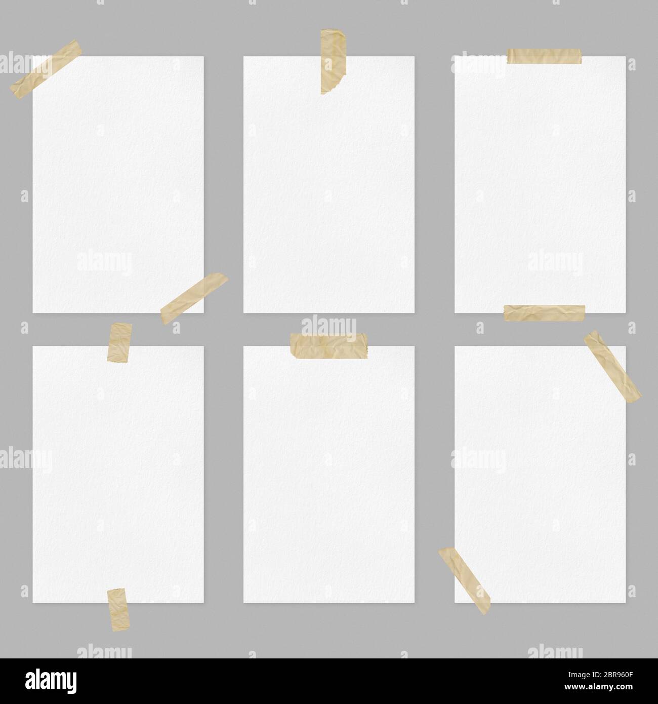 Set of blank white paper sheets with adhesive tapes on light gray ...