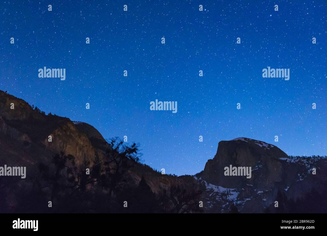 scene of half dome with sky at night before full moon set in Yosemite ...