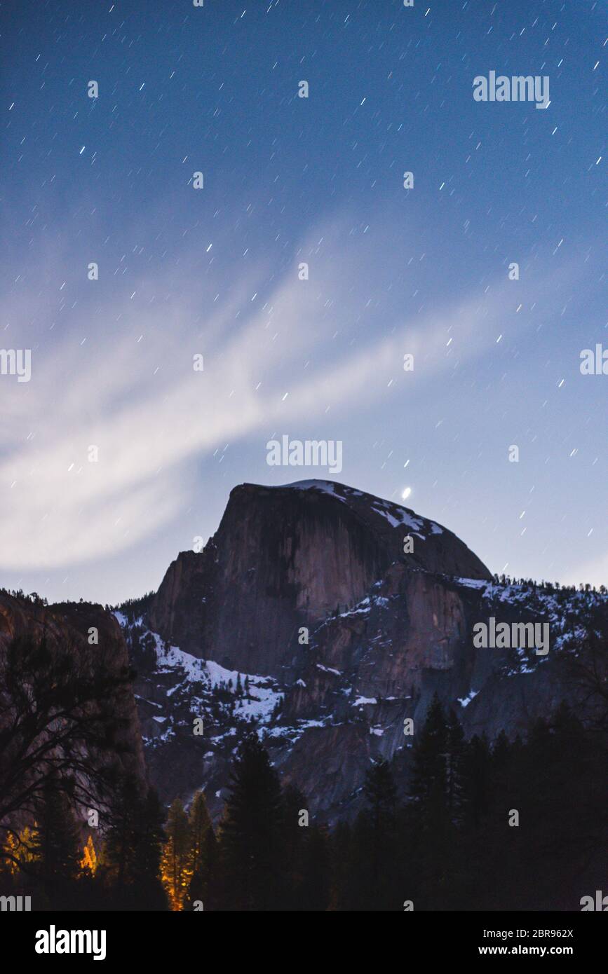 scene of half dome with sky at night before full moon set in Yosemite ...