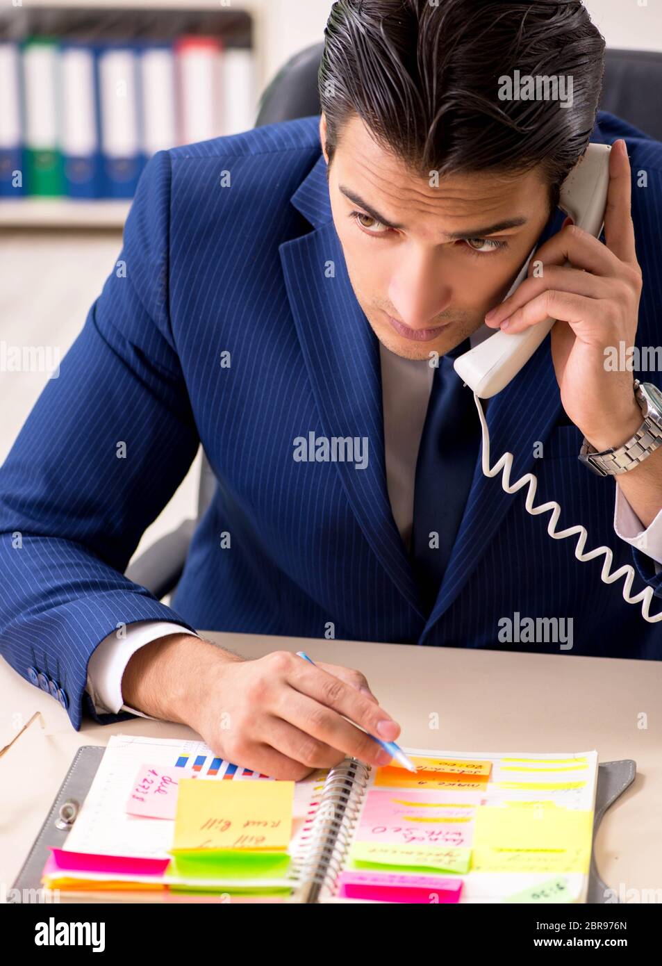 The young handsome employee planning his work activity Stock Photo - Alamy