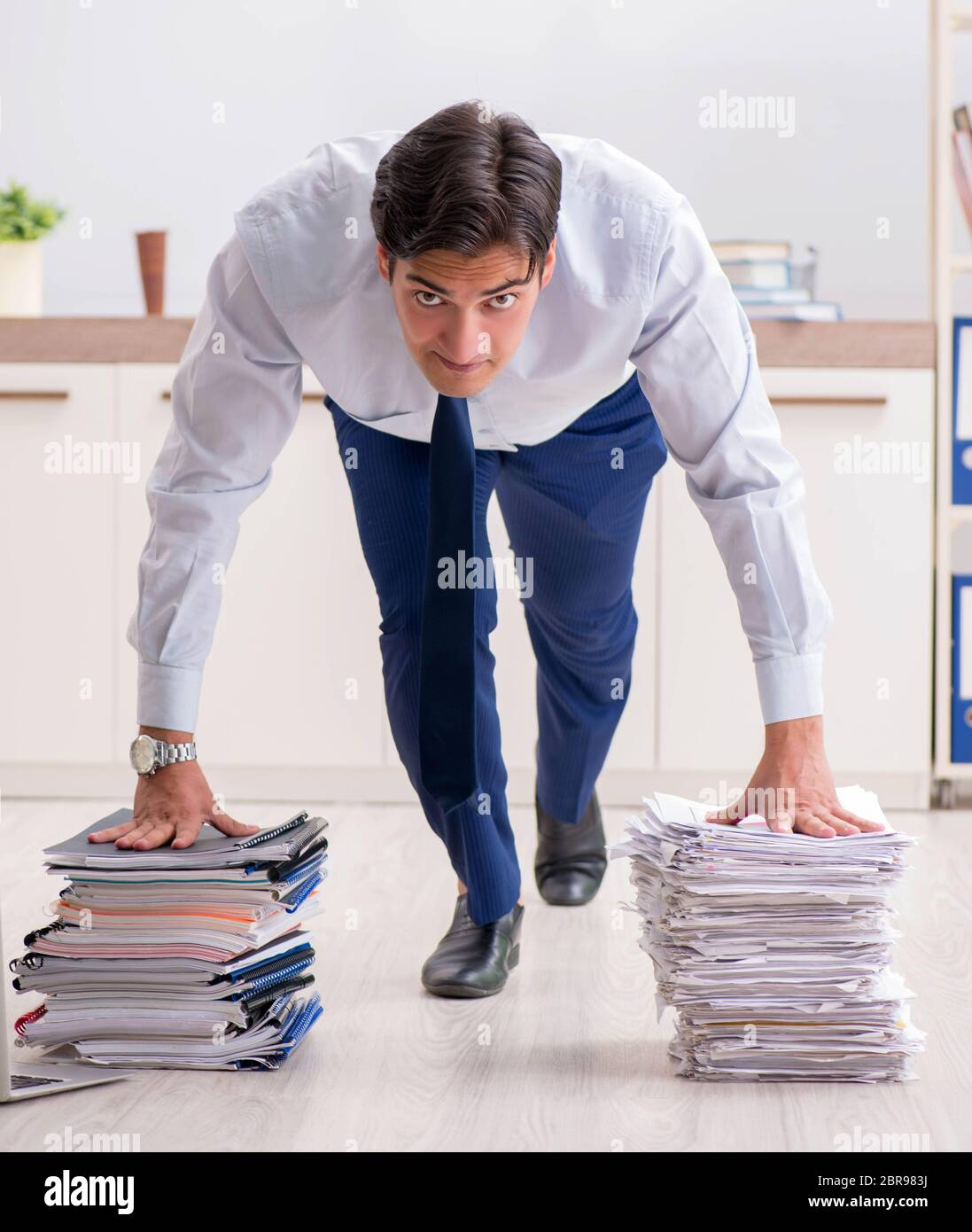 The extremely busy employee working in the office Stock Photo - Alamy