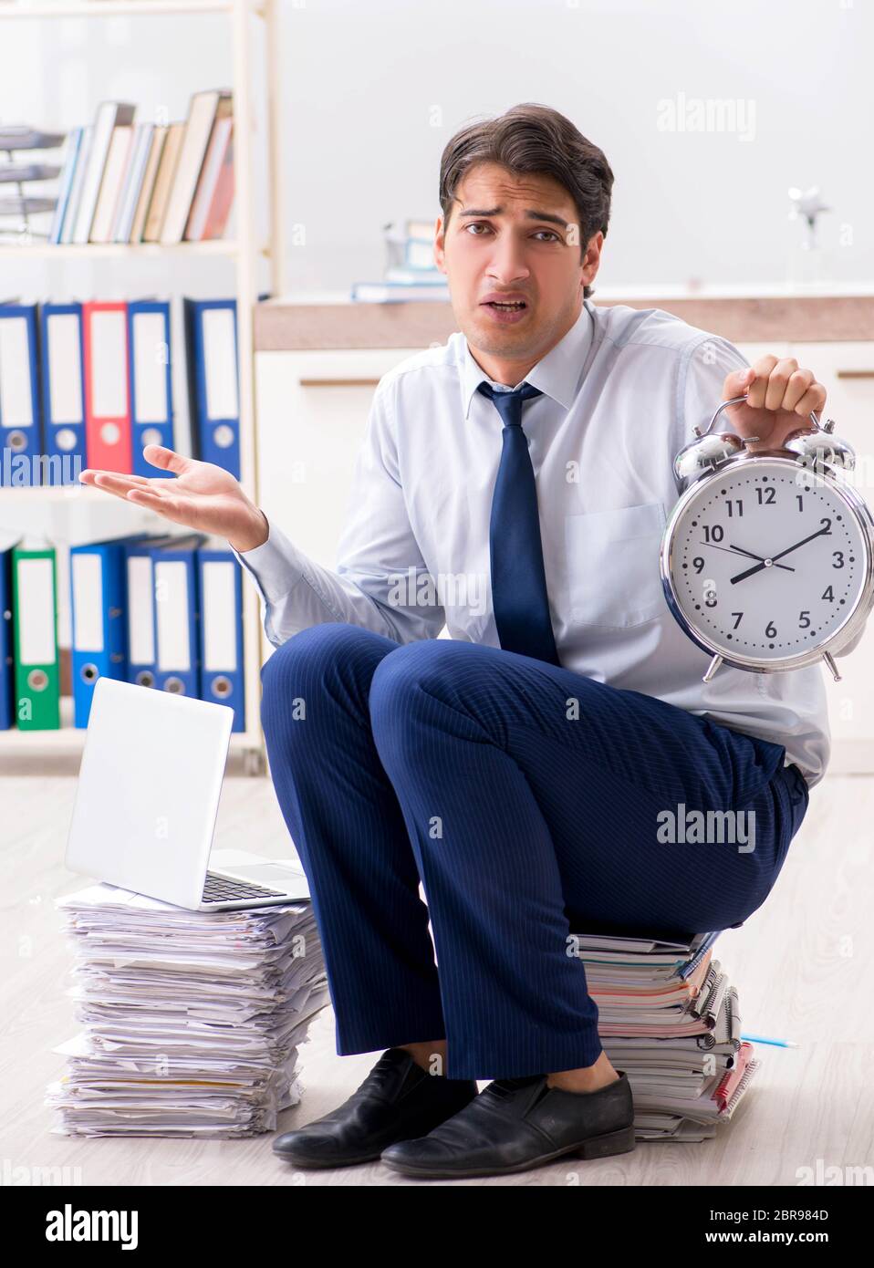 The extremely busy employee working in the office Stock Photo - Alamy