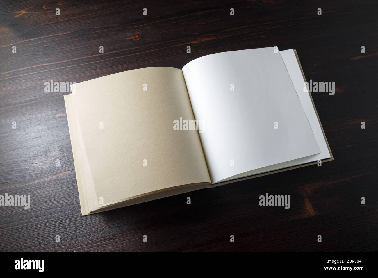 Blank open booklet on wooden background. Responsive design template ...