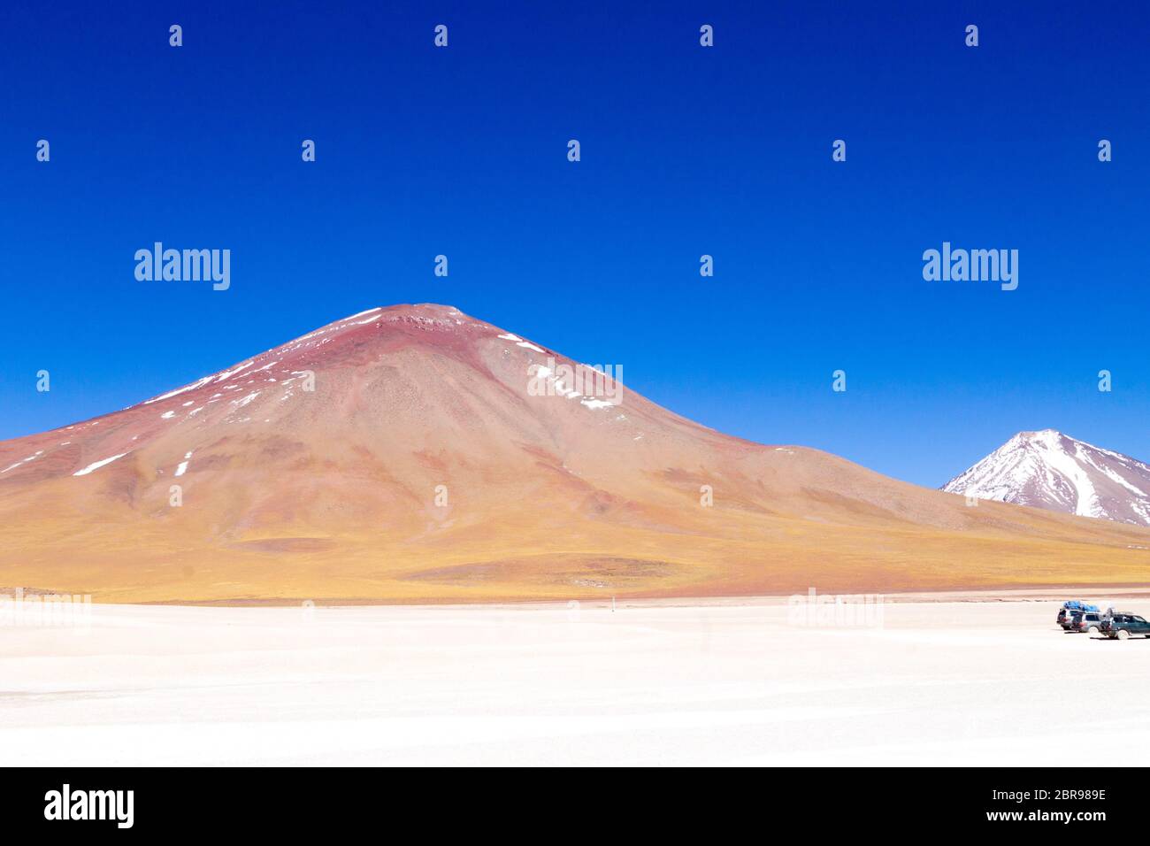 Bolivia adventure. Off road vehicles under Licancabur volcano. Bolivian ...