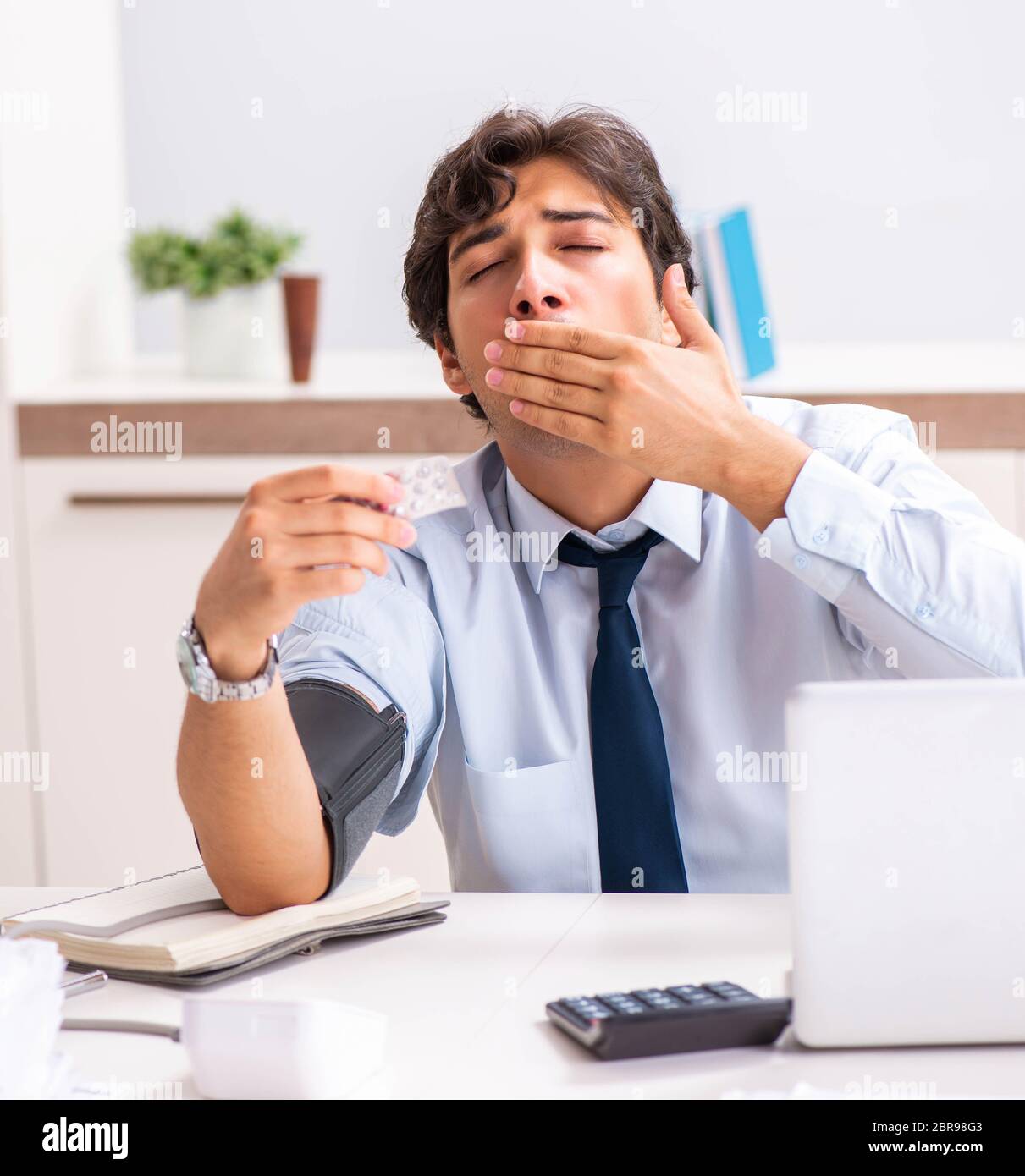 The man under stress measuring his blood pressure Stock Photo - Alamy