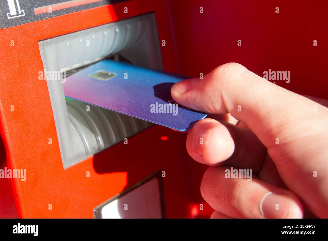 Hand of a man with a credit card, using an ATM. Man using an atm ...