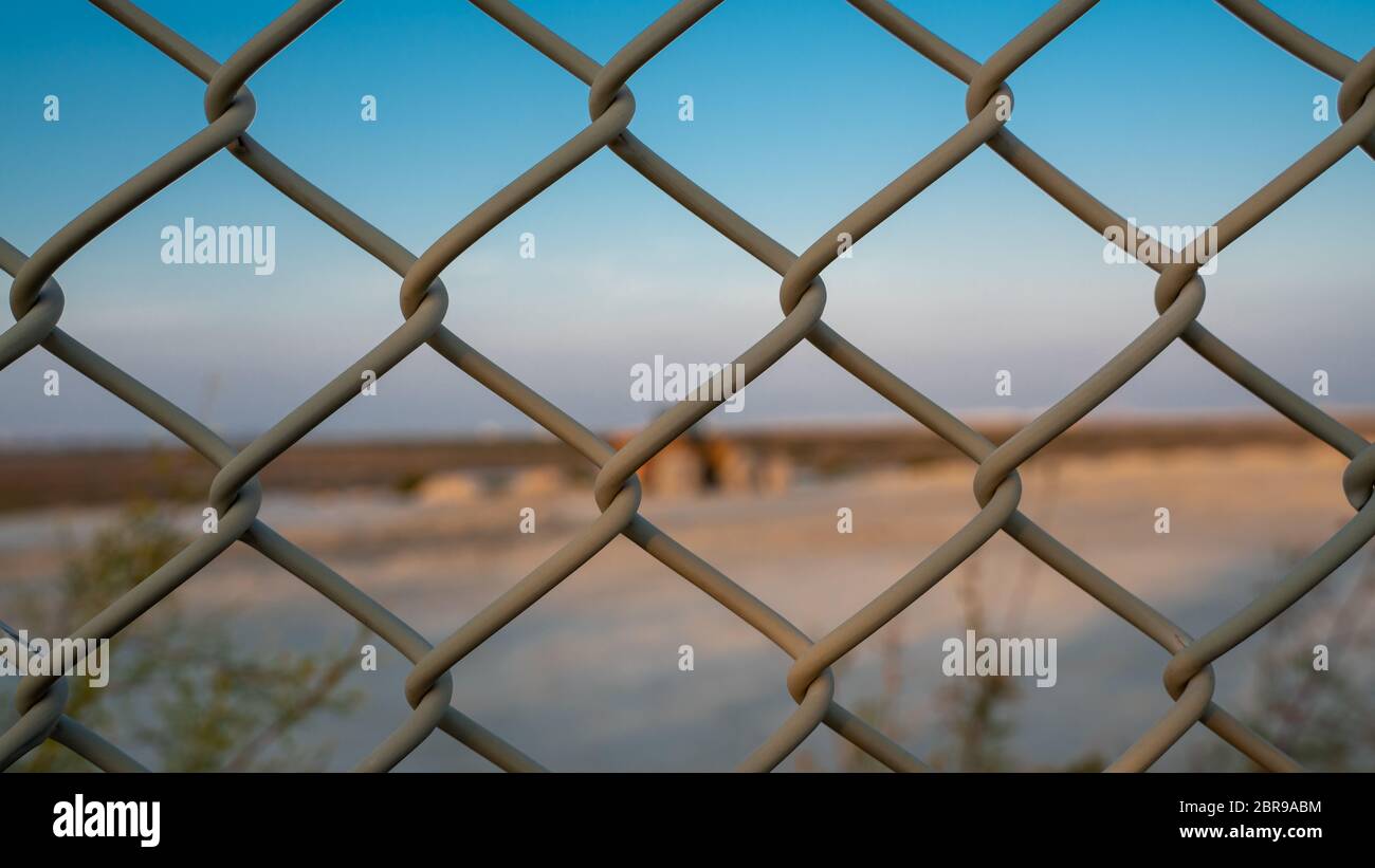 Background image of a garden chain link fence fence Stock Photo - Alamy