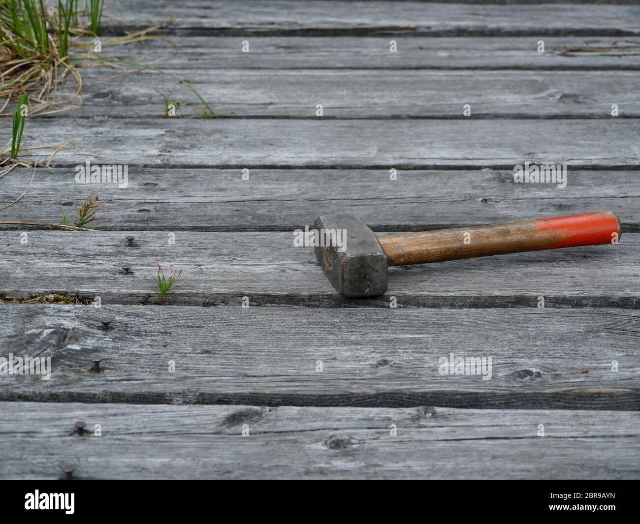 sledgehammer on the boards old bridge sticking rusty nails Stock Photo ...