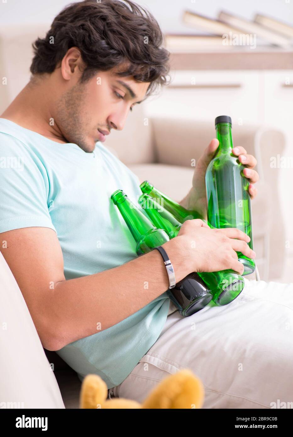 The young drunk handsome man after party at home Stock Photo - Alamy