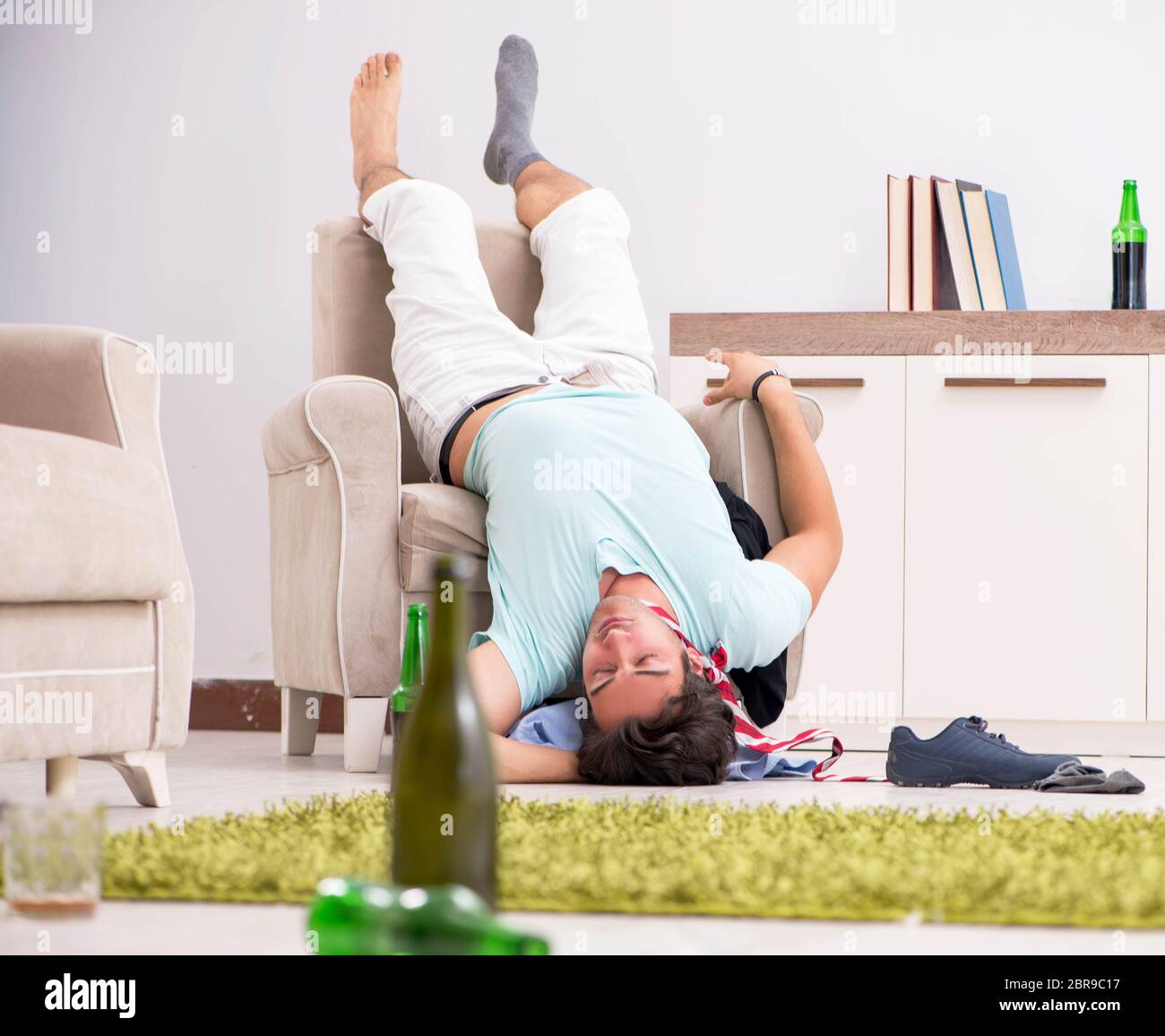 The young drunk handsome man after party at home Stock Photo - Alamy