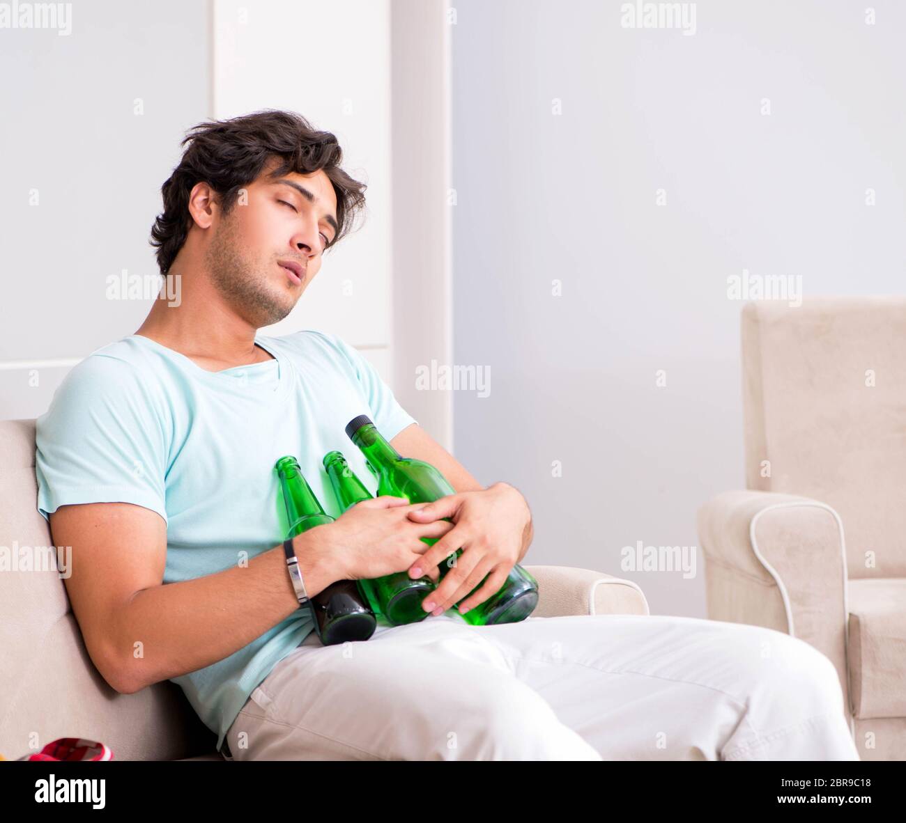 The young drunk handsome man after party at home Stock Photo - Alamy