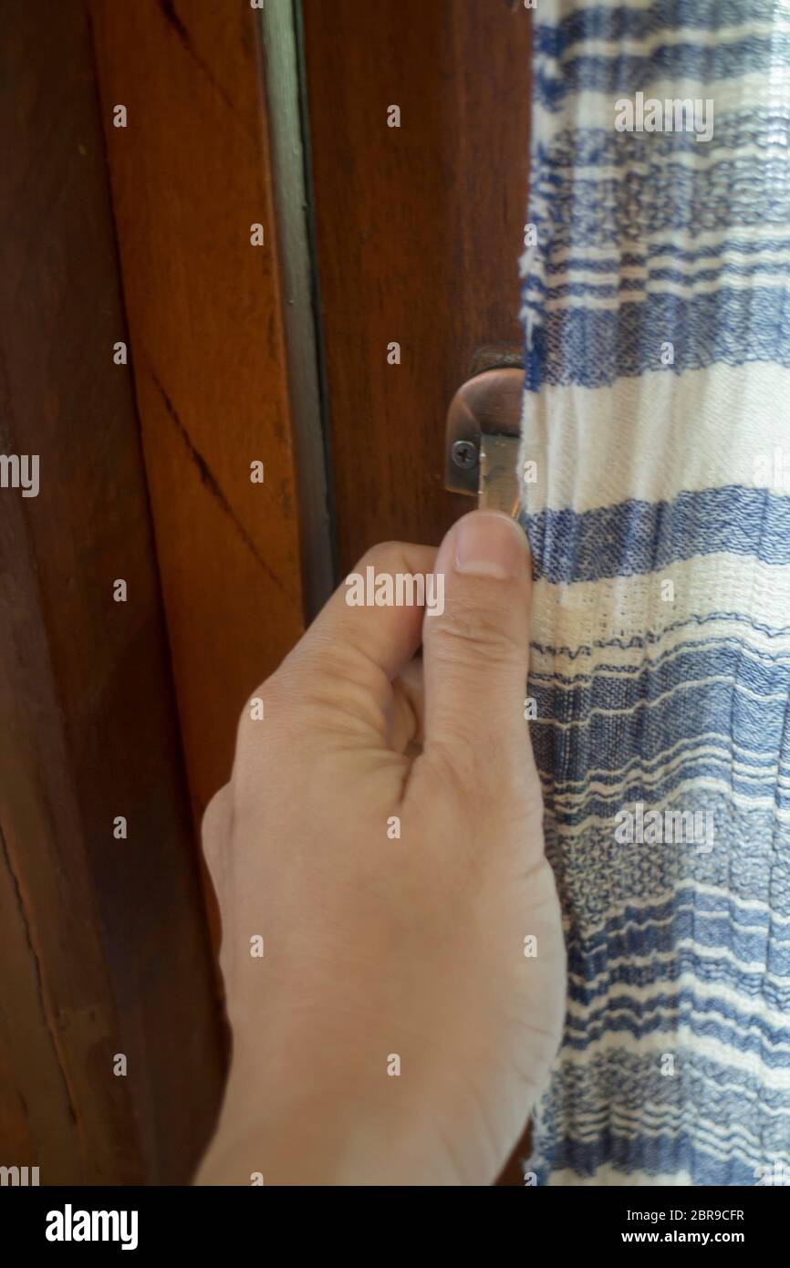 Hand on cotton curtain of window, stock photo Stock Photo - Alamy