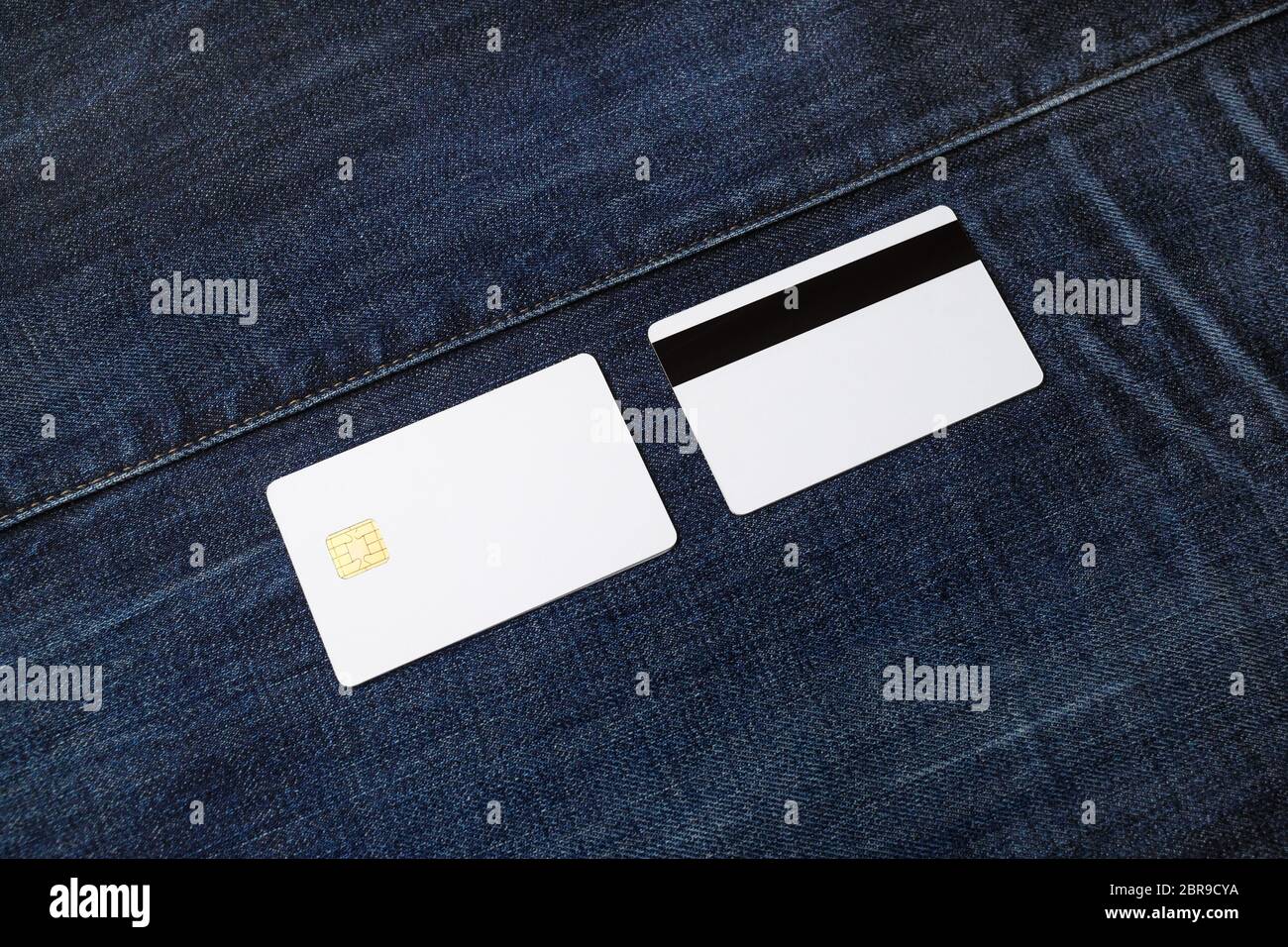 Two white blank credit cards on denim background. Chip cards. Front and ...