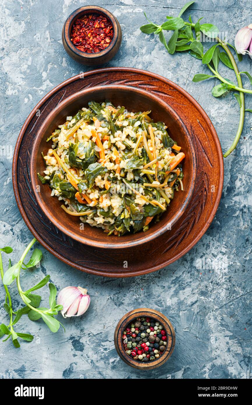 Popular food of the Middle East.Stew bulgur.Bulgur with portulak Stock ...