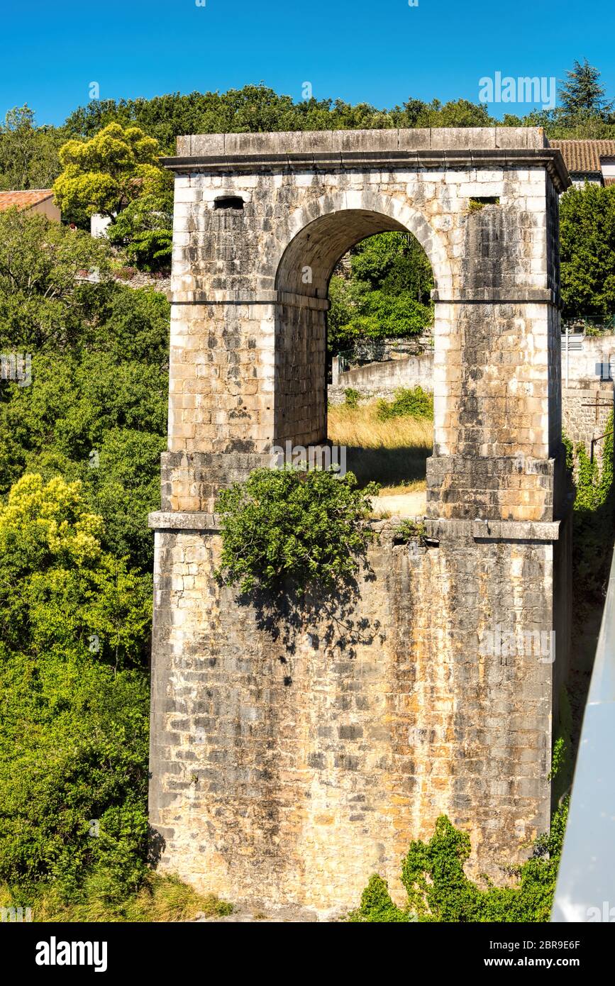 Old archway of a bridge in the village Ruoms at the river Ardeche in ...