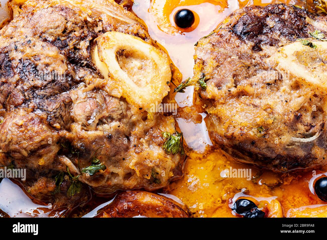 Ossobuco, traditional dish of Italian cuisine. Stewed veal leg Stock ...