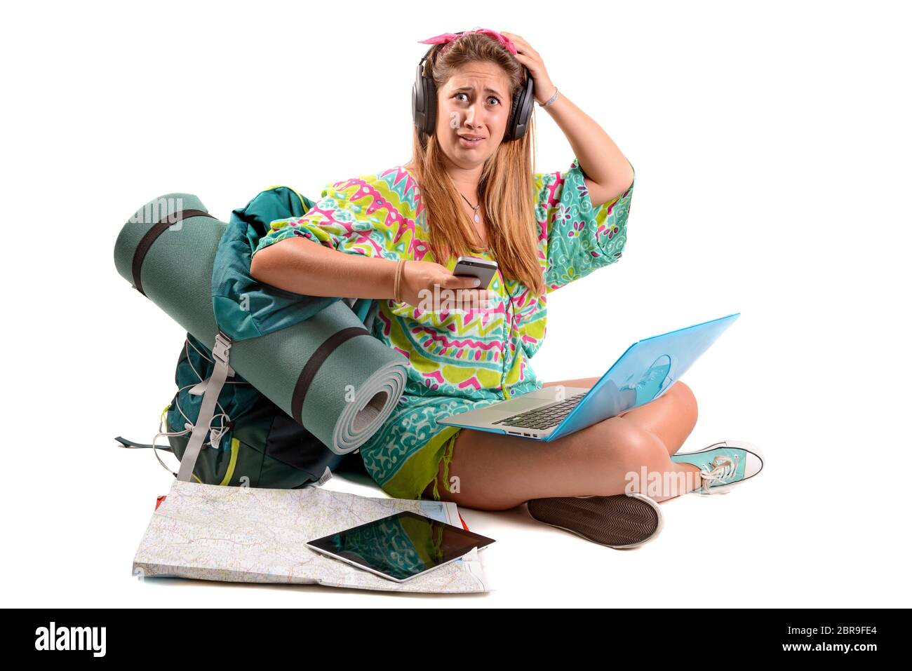 Lost and stressed girl with many devices looking for directions ...