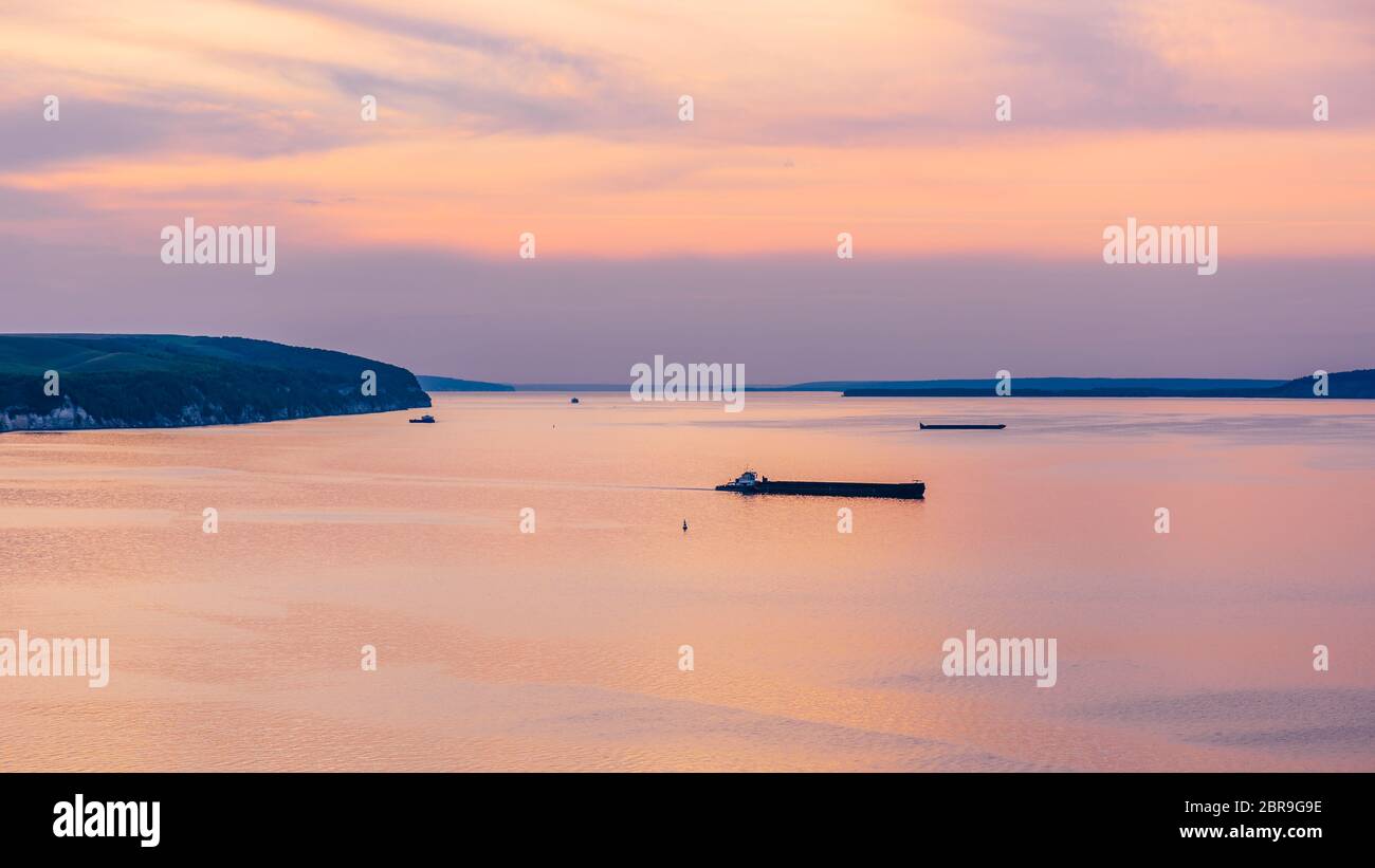 Sunset sky on navigable river with reflection on water Stock Photo - Alamy