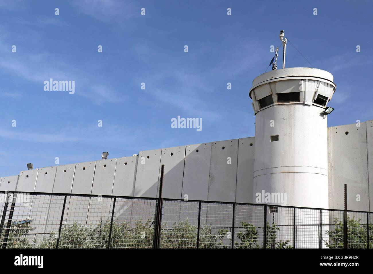 Guard tower in front of border wall between Israel and Palestine near ...