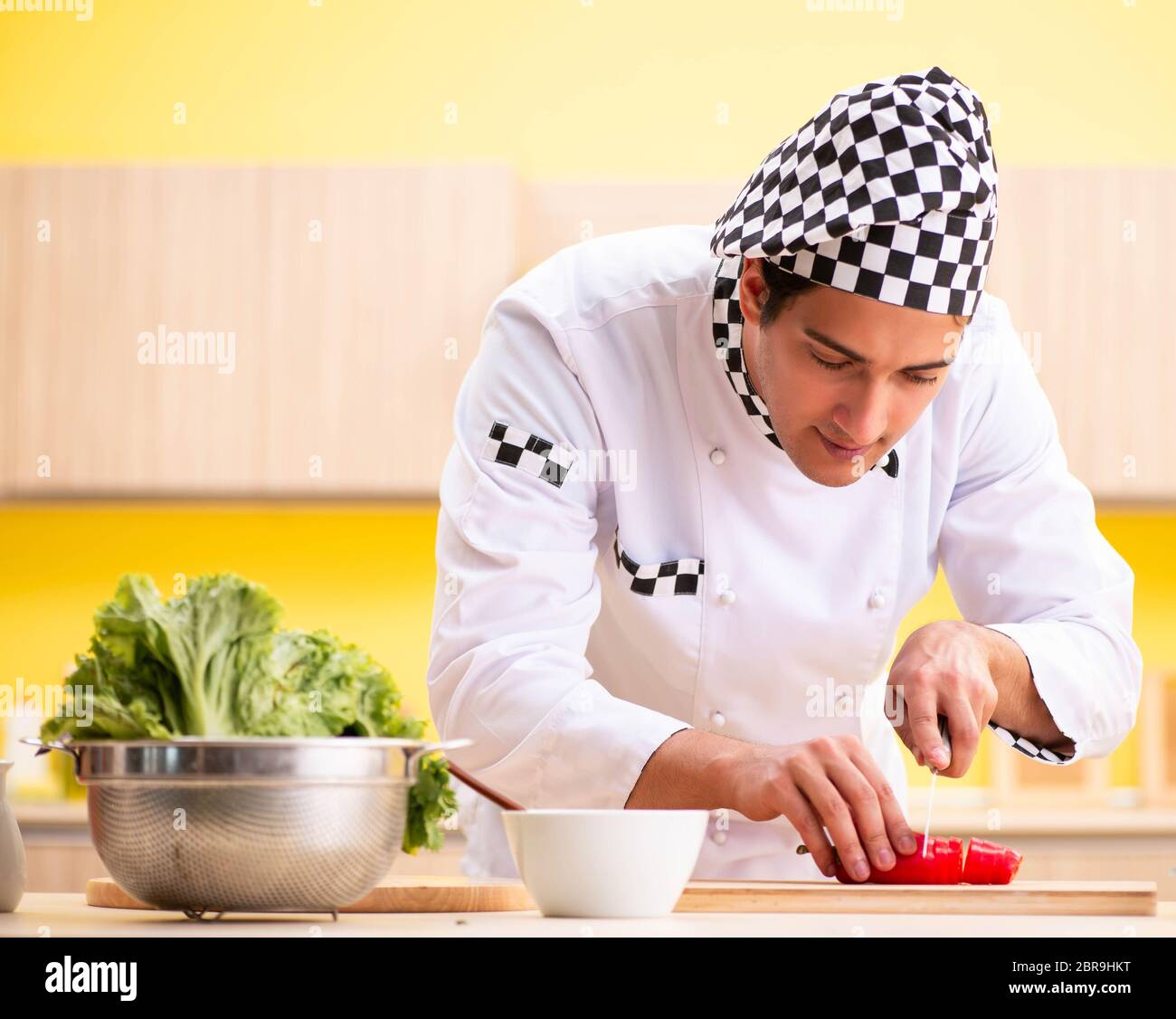 The young professional cook preparing salad at home Stock Photo - Alamy