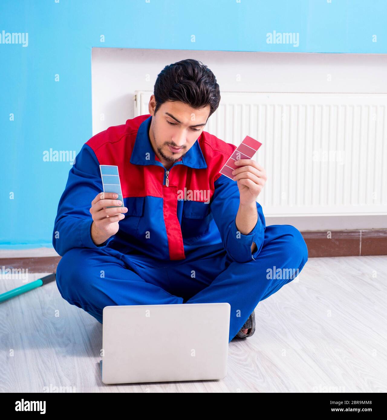 The young man contractor choosing color from rainbow Stock Photo - Alamy