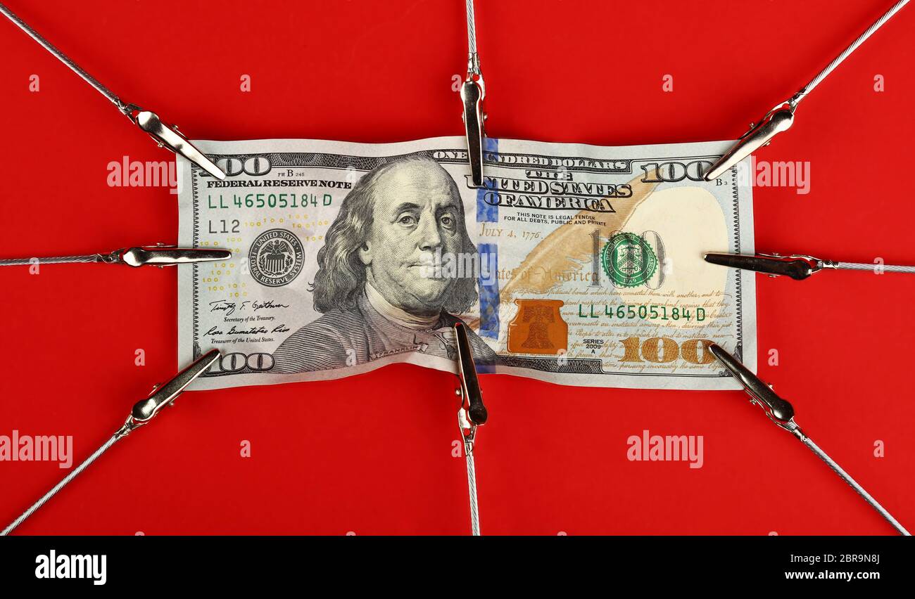 Close up one hundred US dollar paper currency banknote pulled and ...