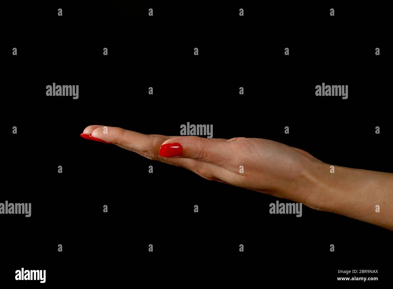 Woman hand palm with red nails holding or presenting something over ...