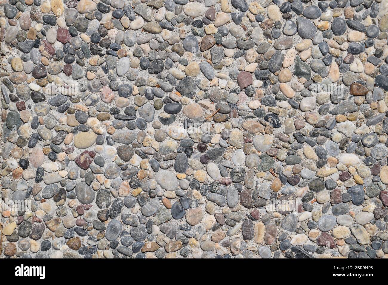 Background texture of the pavement of stone pellets. Pebbles in ...