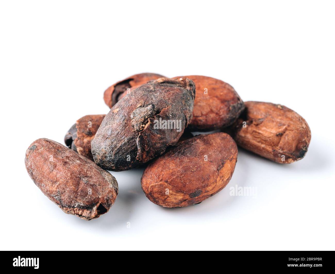 Raw cacao beans top view on white background. Close up view of raw ...
