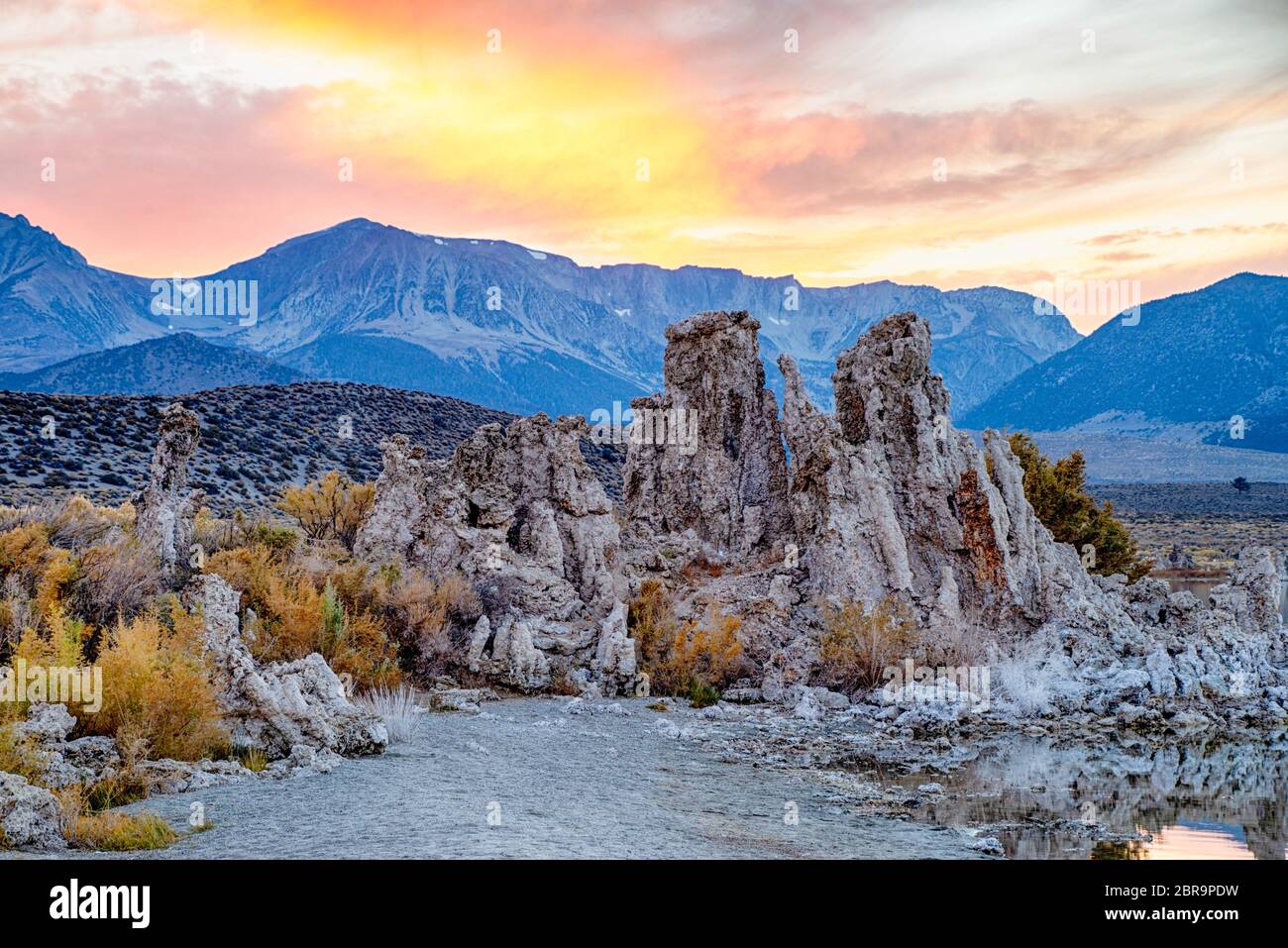 Ancient lake in a crater of an extinct volcano. Tufa stalactites are ...