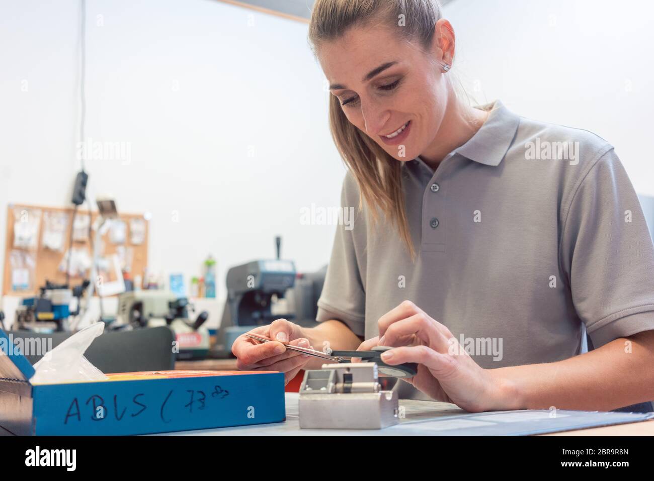 Woman locksmith repairing a lock using tool to measure a part Stock ...