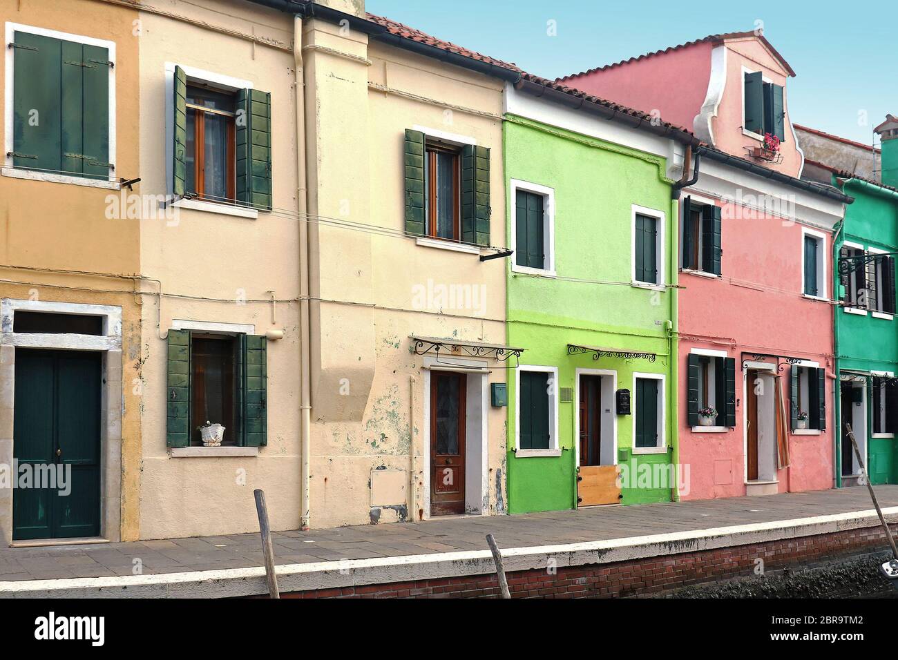 Retro residential houses with colorful facades and old doors and ...