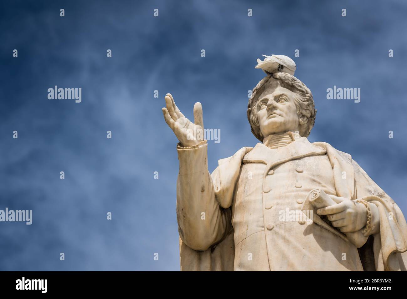 White bird sitting on top of ancient statue of Dionysios Solomos in ...
