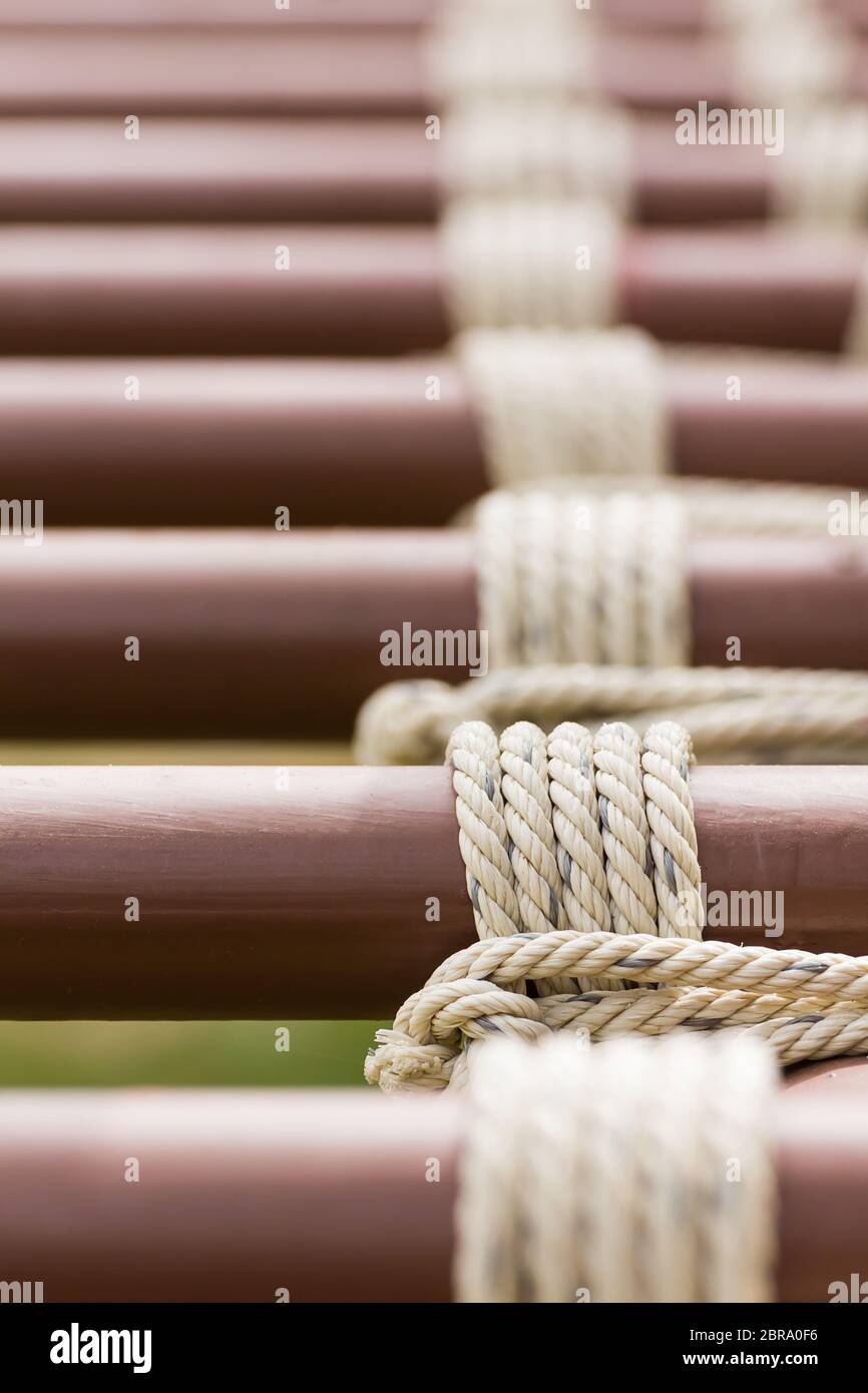 Close up of rope tied knot around metal pipe Stock Photo - Alamy