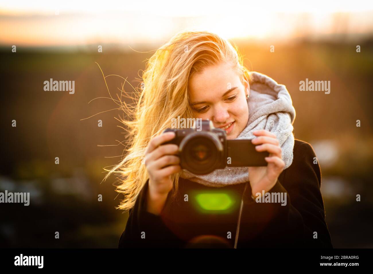 Cute female photographer with her dslr camera taking photos outdoor at ...