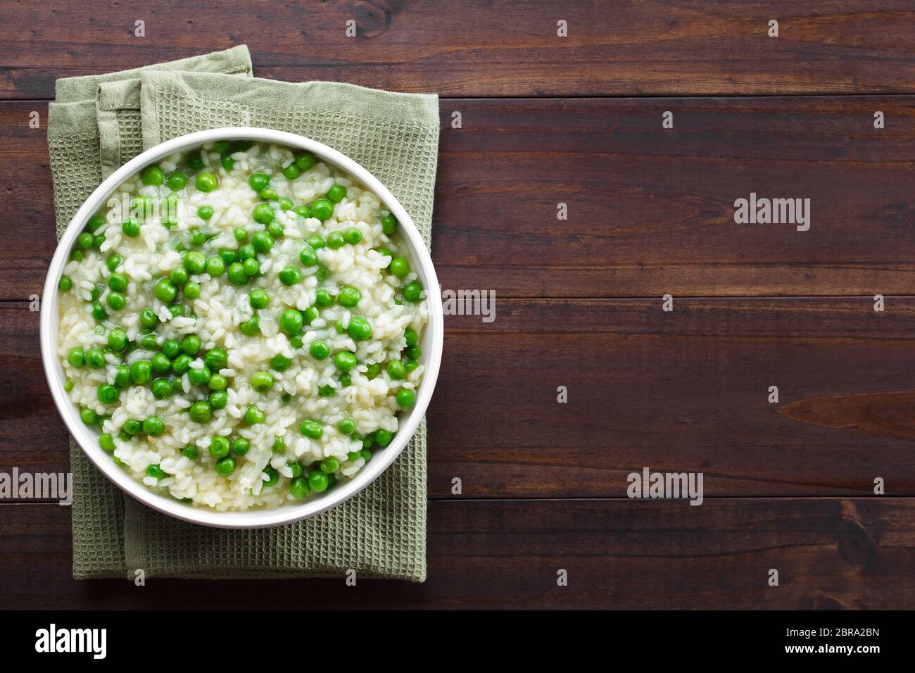 Fresh homemade creamy green pea risotto in bowl, photographed overhead ...