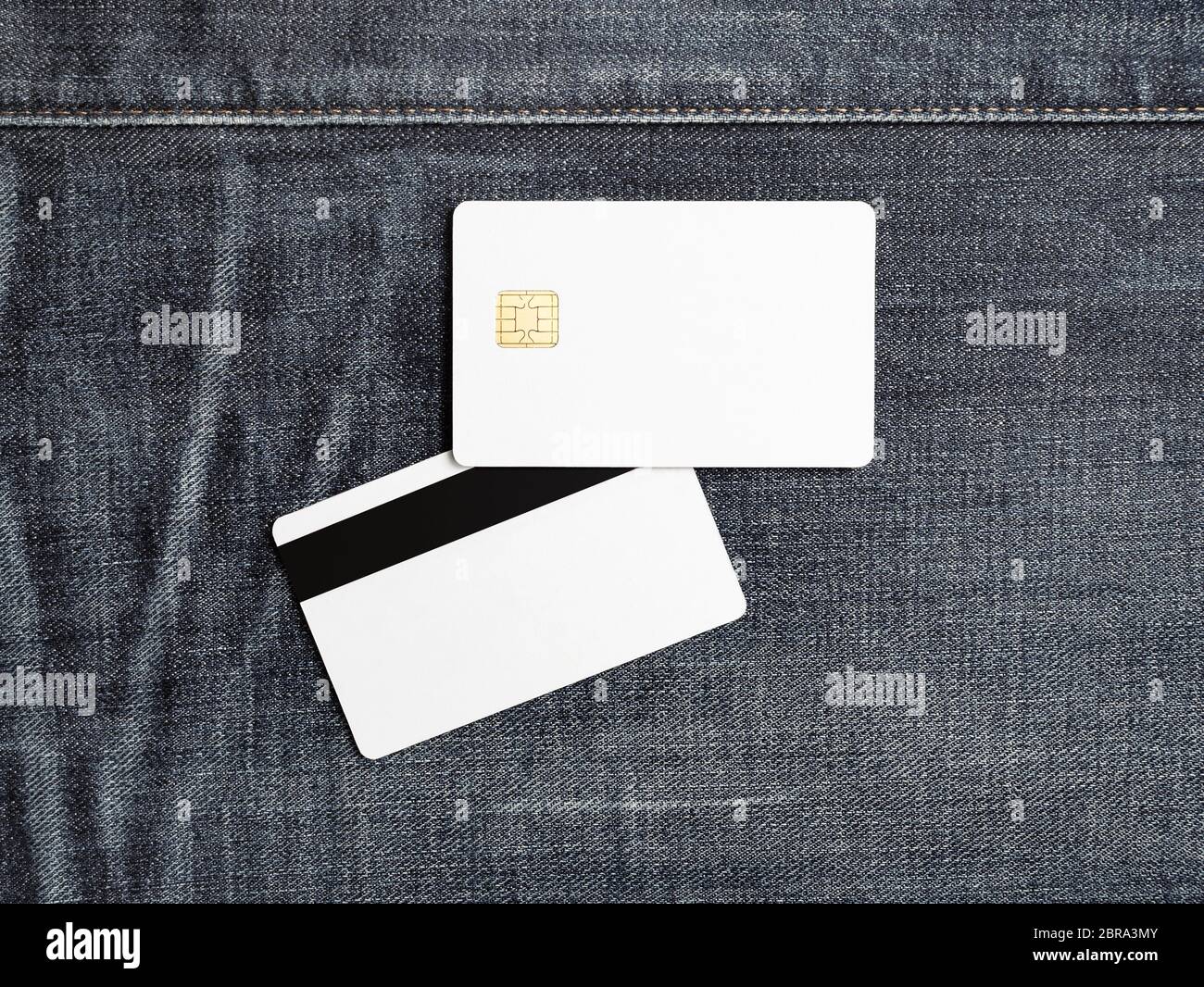 Photo of blank plastic bank cards on denim background. White credit ...